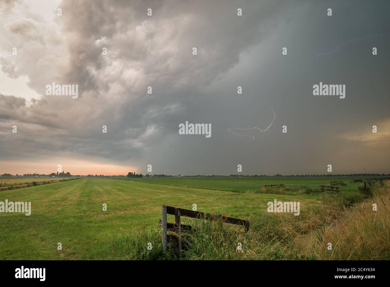 Thunderstorm with lightning bolt is moving across the dutch landscape ...