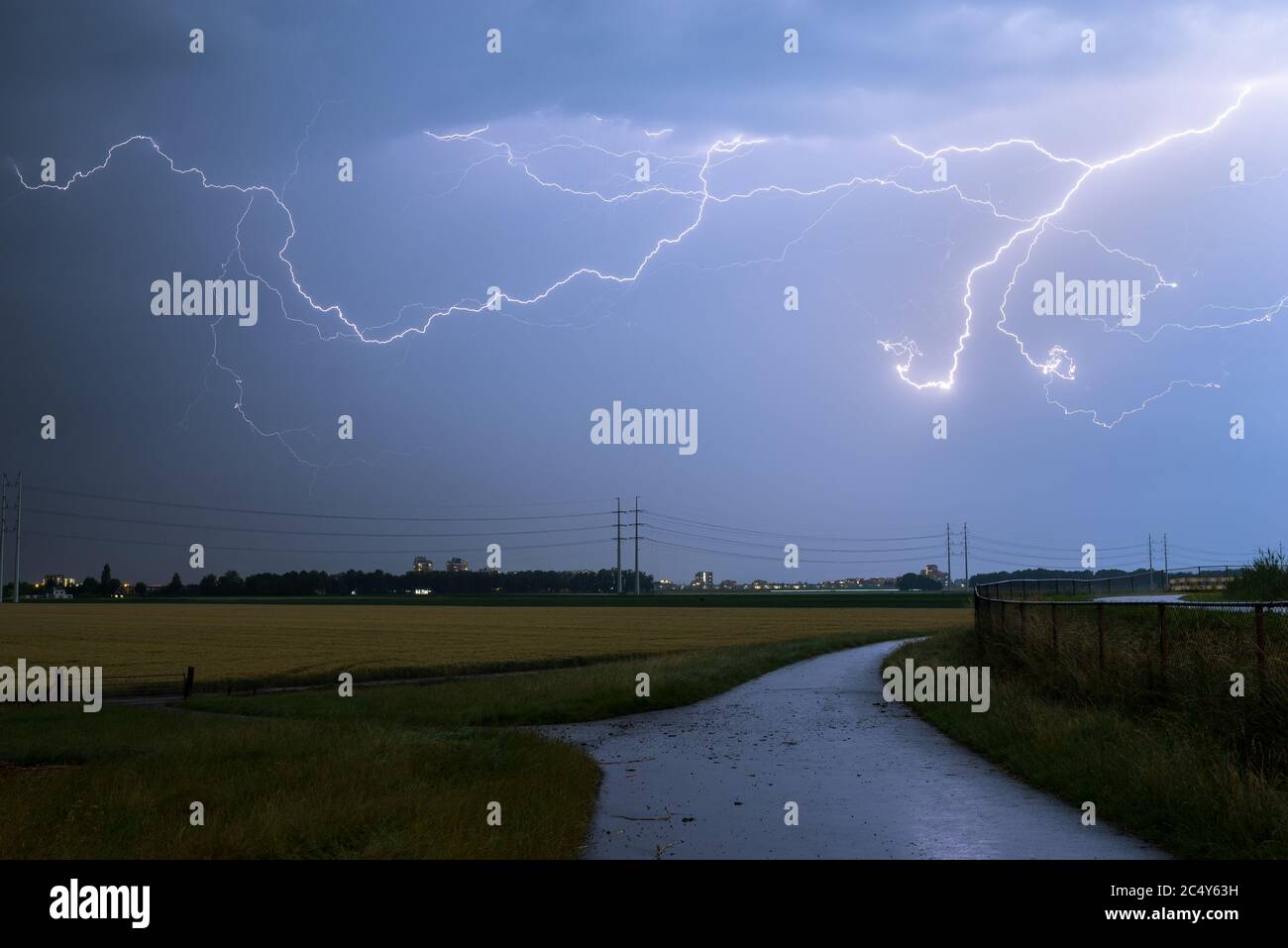 Strong thunderstorm with bright lightning bolts traveling through the ...