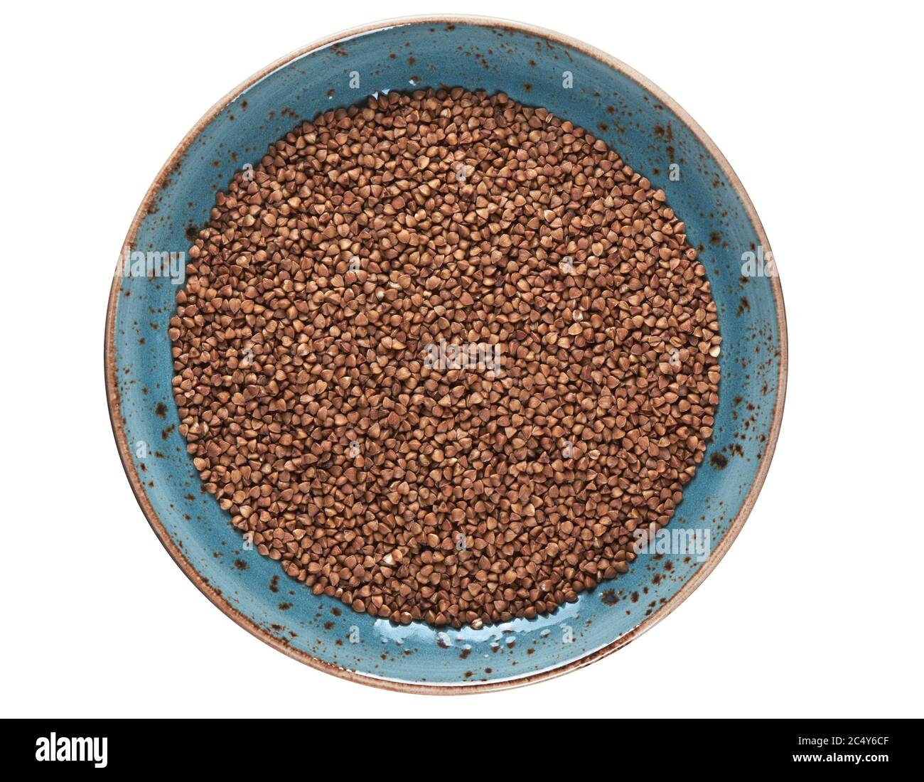 uncooked buckwheat in a plate isolated on white background. Top view ...