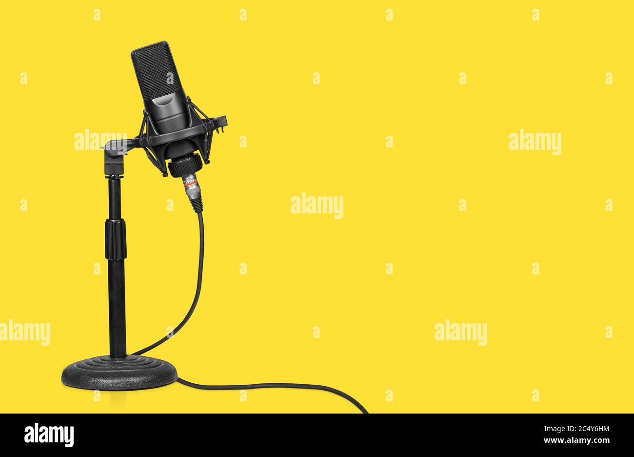 professional microphone on a table stand over yellow background Stock ...