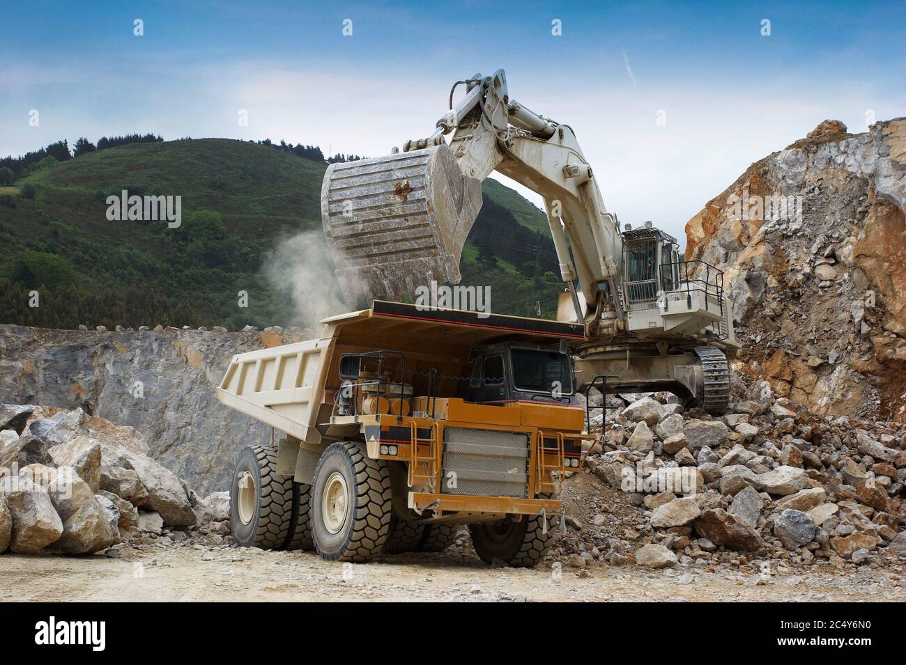 stone quarry excavator loading the dumper Stock Photo - Alamy
