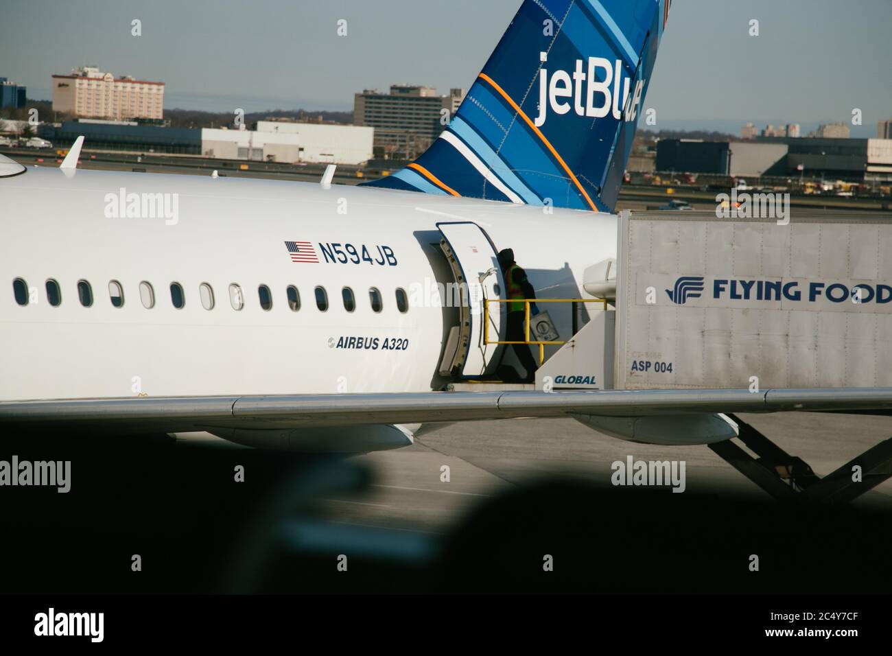 A flight controller boards a Jetblue airbus A320 from a terminal Stock ...