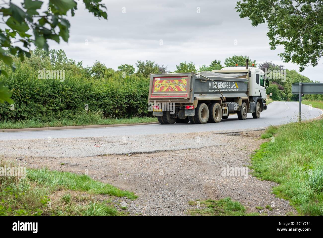 Large aggregate tipper truck seen negotiating a bend in the English ...