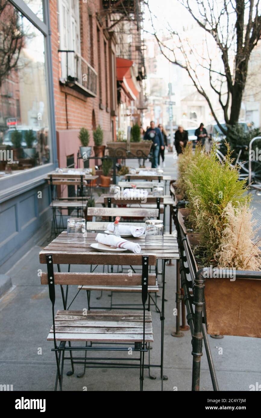 Table and chair setups outside a restaurant in the west village Stock ...