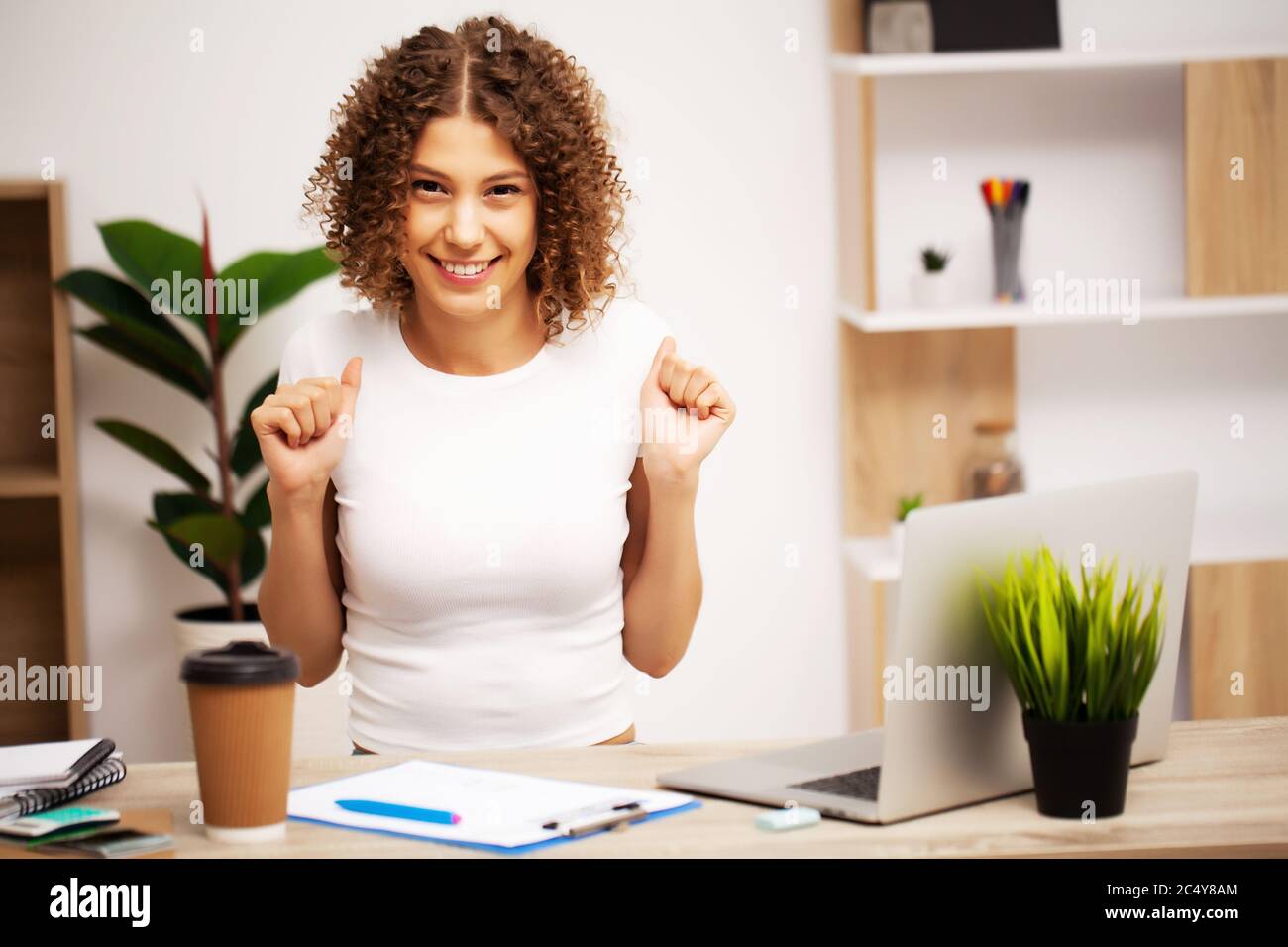 Beautiful business woman with a smile on her face working in the office ...