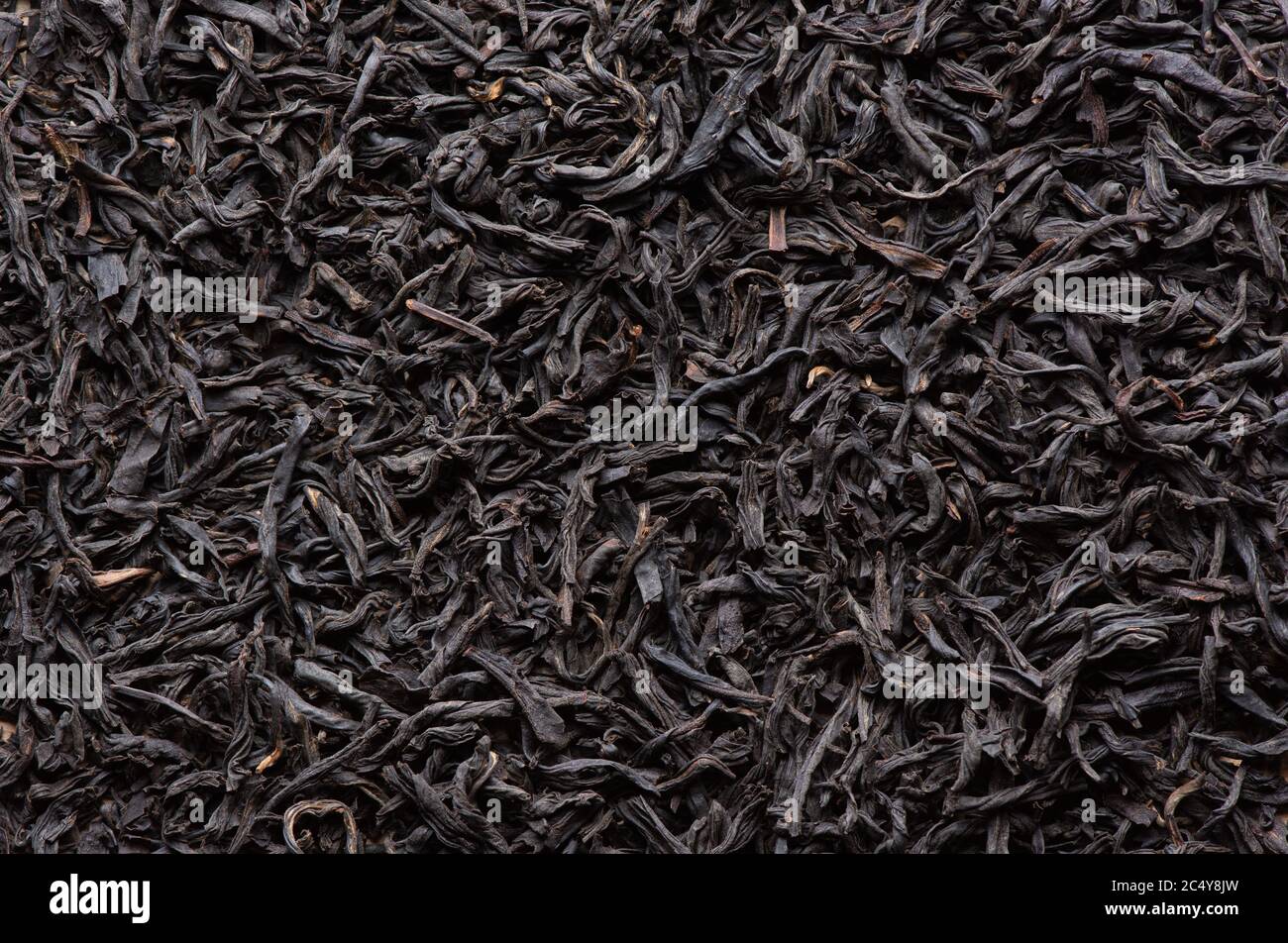 Dry black tea leaves background texture Stock Photo - Alamy