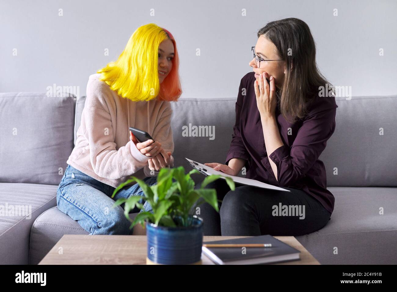 Teen girl giving interview to social worker. School psychologist ...