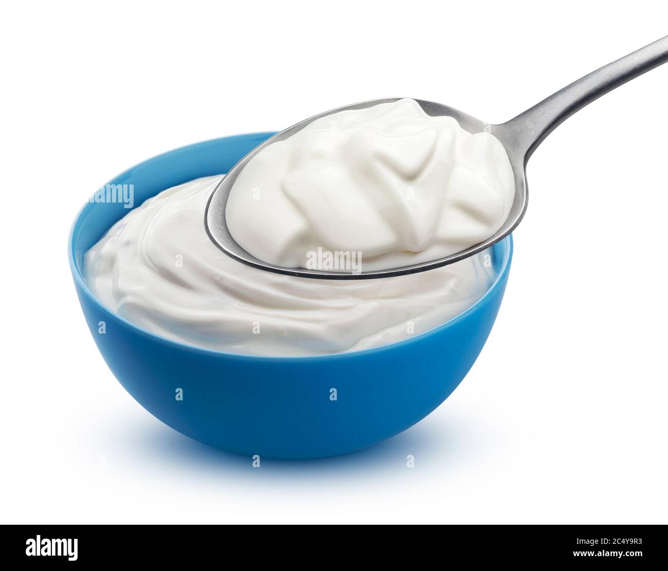 Fresh sour cream in blue bowl with spoon Stock Photo - Alamy