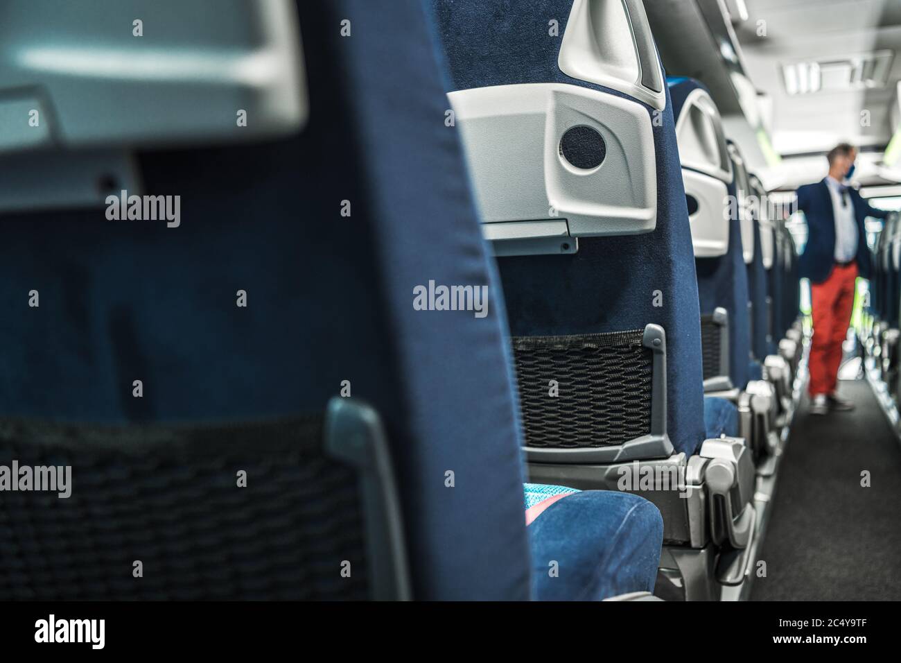 Interior Of Big Coach Bus With Rows Of Blue Fabric Seats And Narrow ...