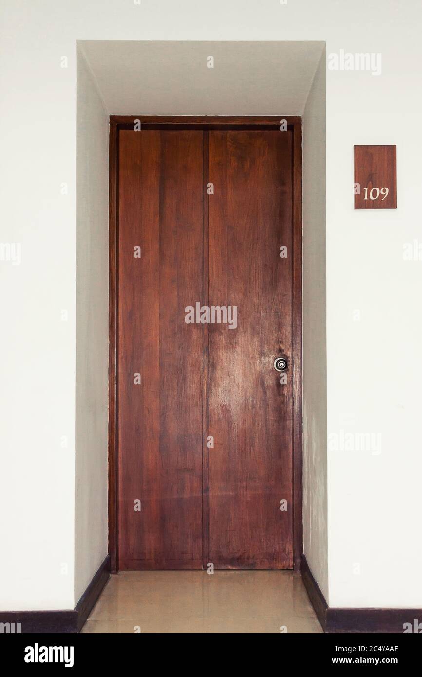 Hotel Room Wooden Door with Room Number Plate extreme closeup Stock ...