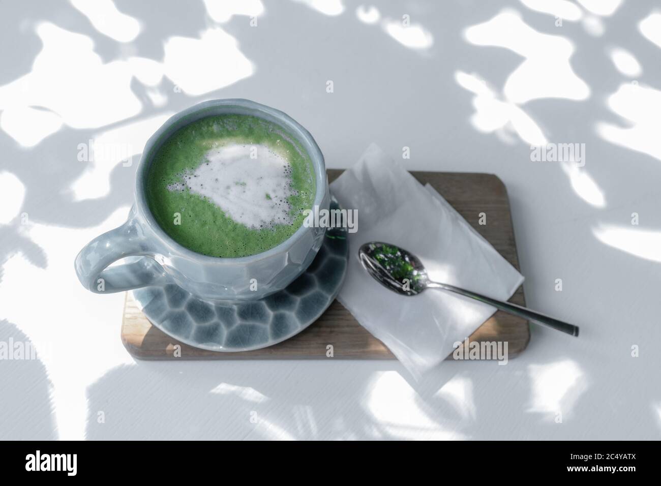 Cup of Green Matcha latte Coffee or Tea on white wooden background with ...