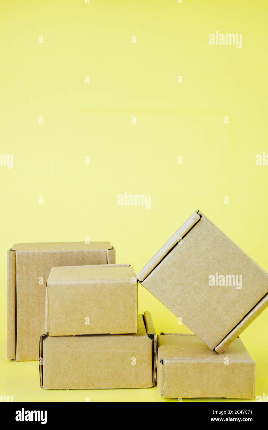 Cardboard boxes of various sizes on yellow background Stock Photo - Alamy