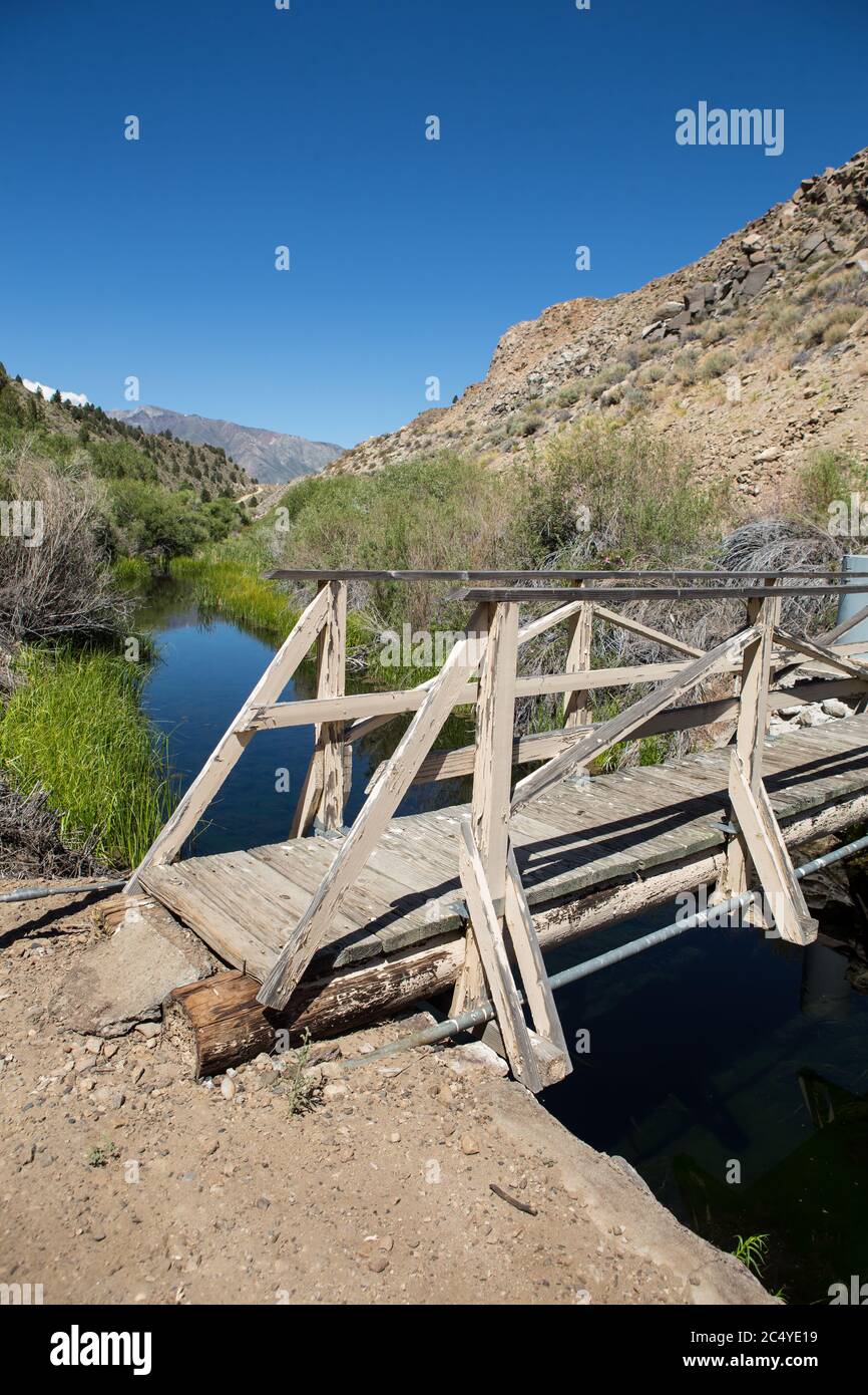 Old rickety wooden bridge over lower rock creek below Long Valley Dam ...