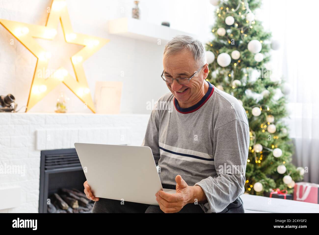 Smiling happy elderly man with laptop Stock Photo - Alamy