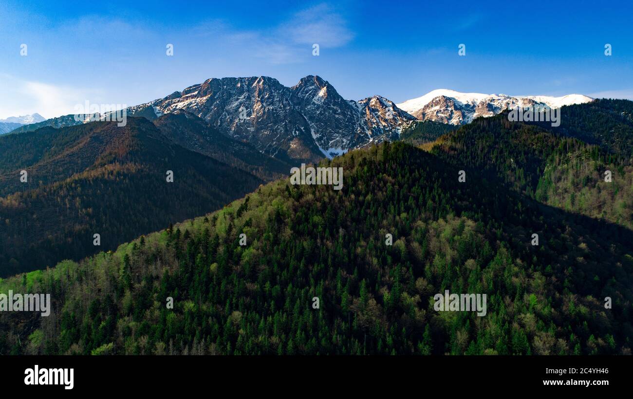 Aerial view of mountains covered with snow in summer or spring. Giewont ...