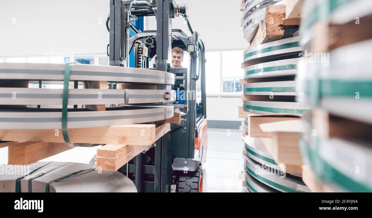 Worker transporting metal material from warehouse to production Stock ...