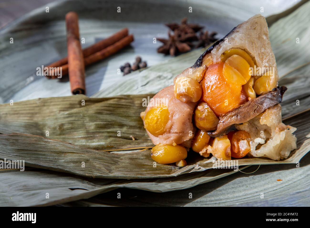 Chinese rice dumpling (Zongzi) shaped pyramidal wrapped by leaves ...