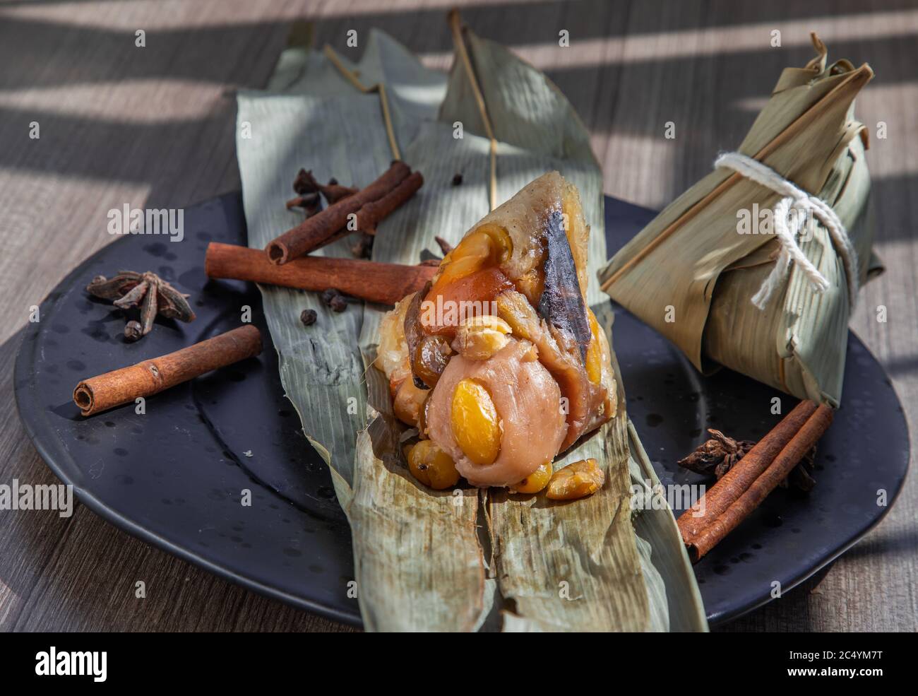 Chinese rice dumpling (Zongzi) shaped pyramidal wrapped by leaves ...