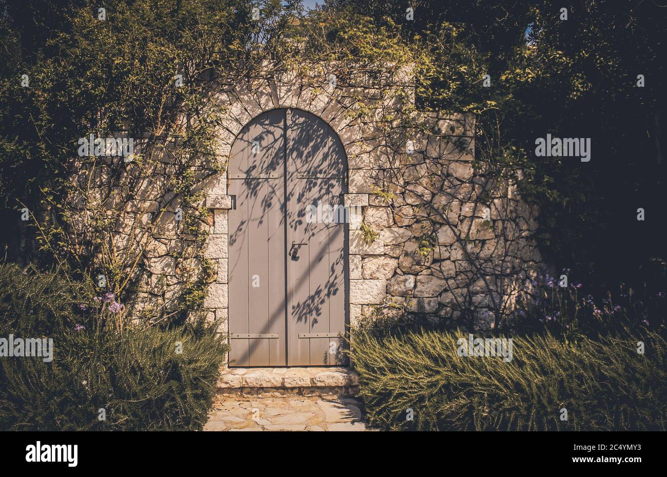 old stone wall and wooden gate Stock Photo - Alamy