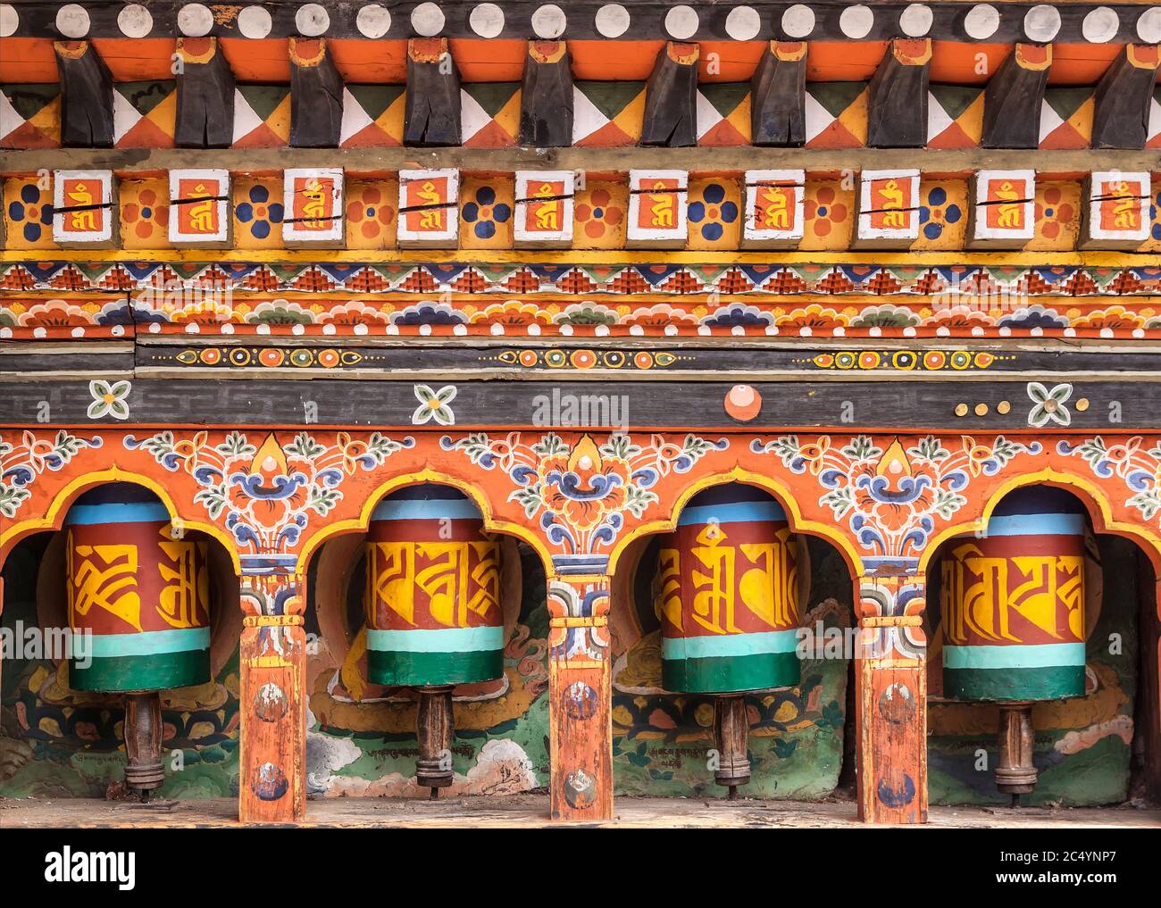 Turning prayer wheels mantra in Bhutan with traditional writing mantra ...