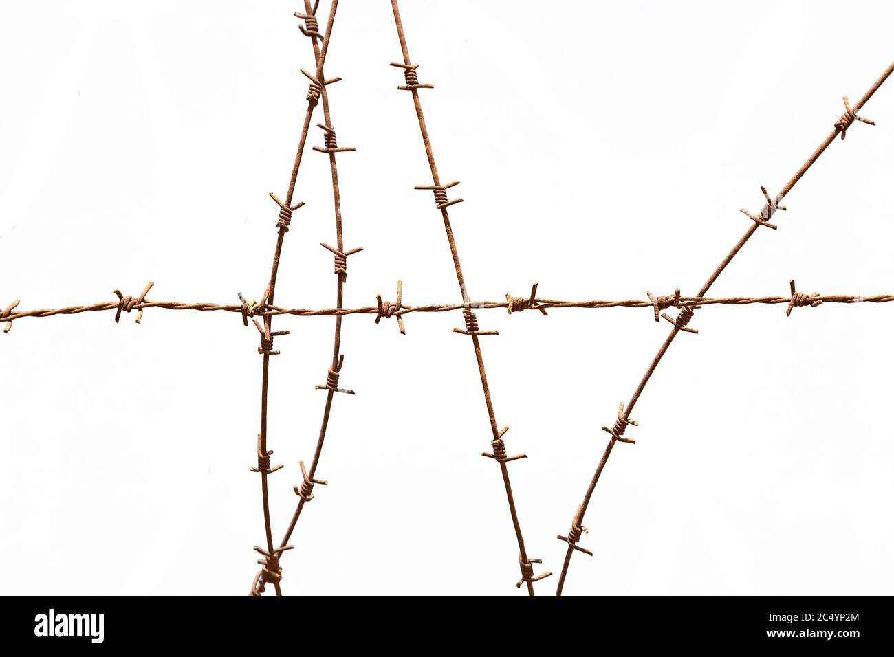 Coiled barbed wire fencing isolated on white background Stock Photo - Alamy