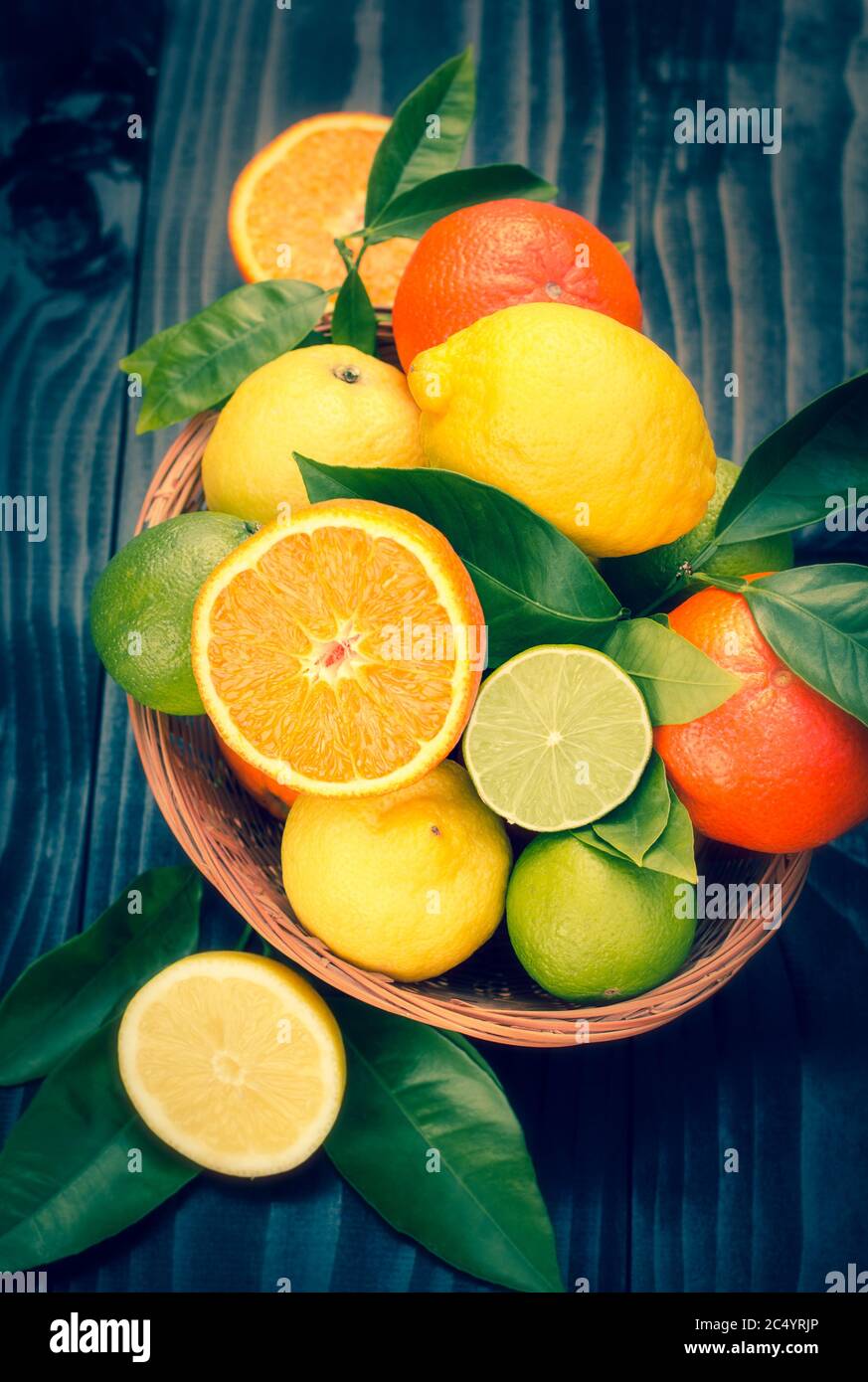 Fresh and juicy citrus fruits in the basket on the rustic table Stock ...