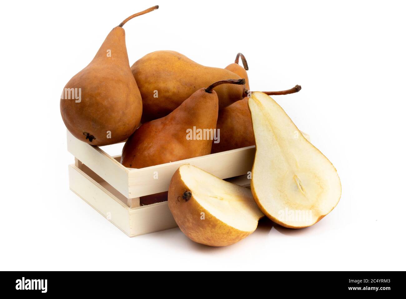 a group of Bosc pears in a wooden crate box with one pear cut open ...