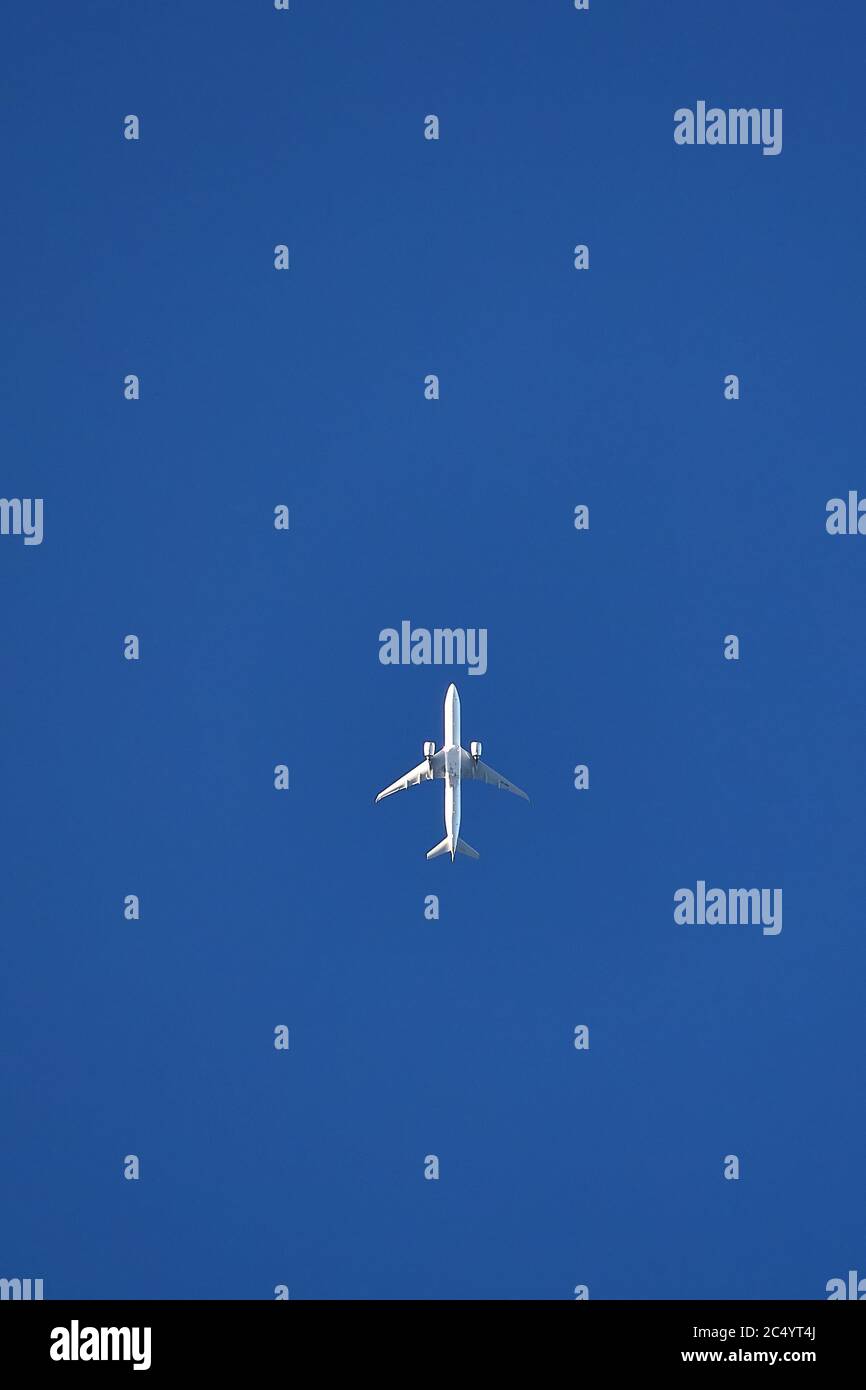 Plane in the clear sky. bottom view Stock Photo - Alamy