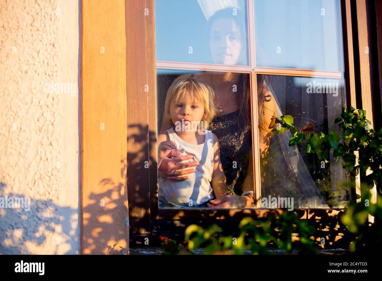 Child, toddler boy, looking through window outside Stock Photo - Alamy