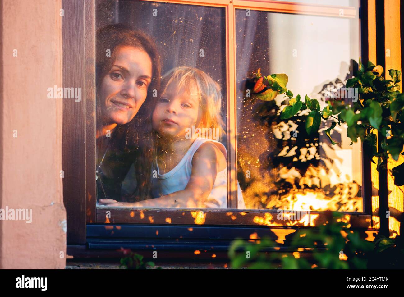 Child, toddler boy, looking through window outside Stock Photo - Alamy