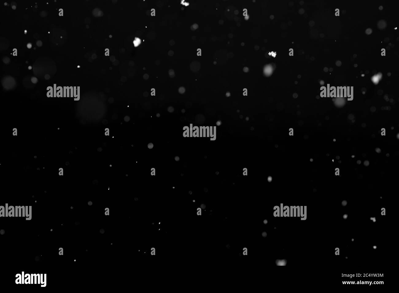 Snowfall on black background Stock Photo - Alamy