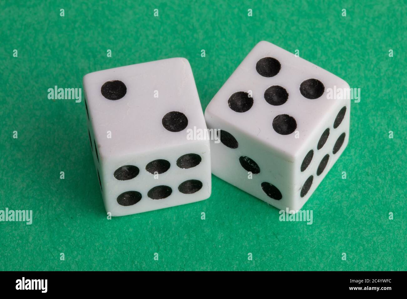 lucky seven - a pair of dice on a green background showing two and five ...