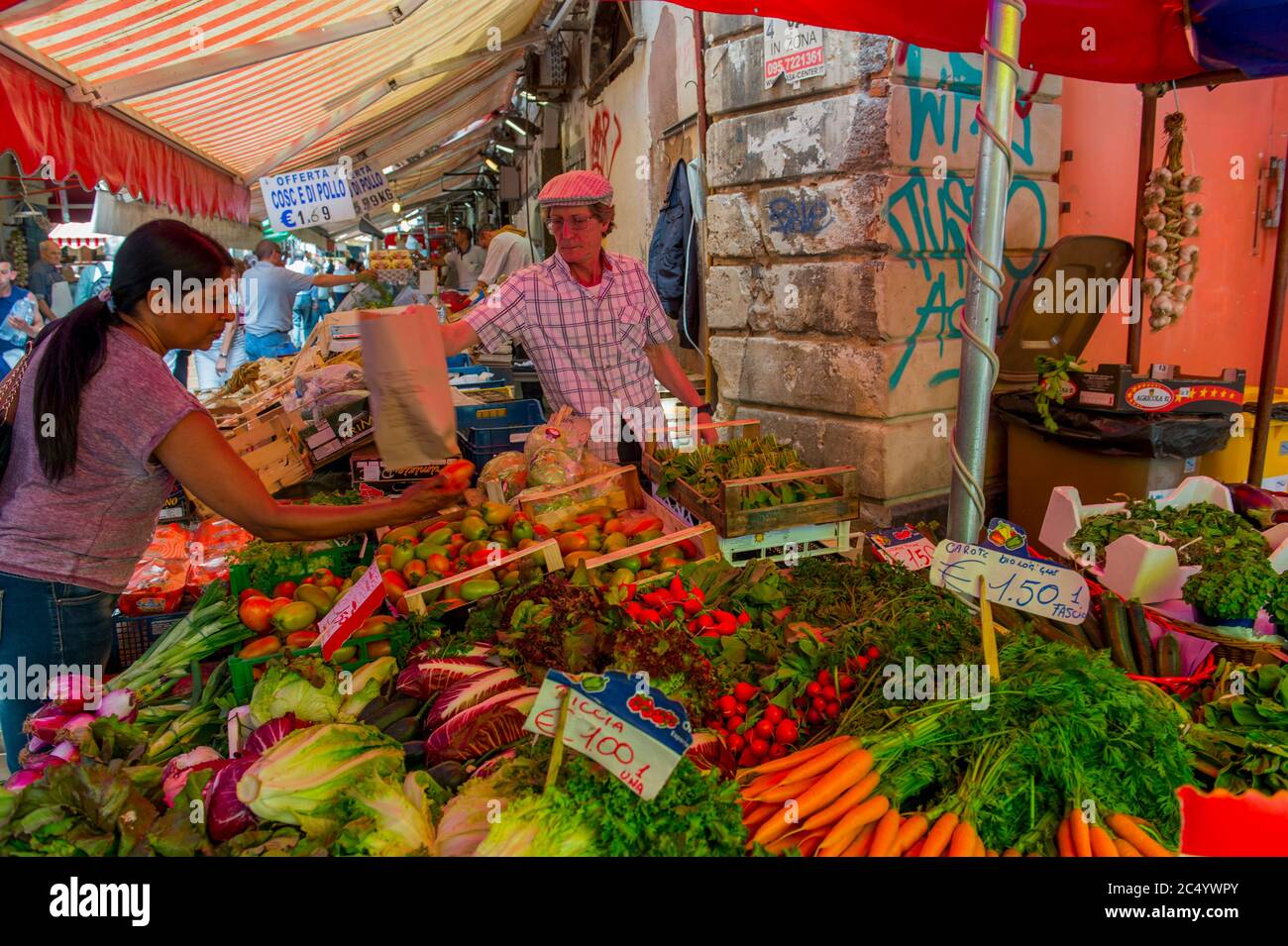 Produce vendors selling fruits and vegetables on the outdoor market in ...