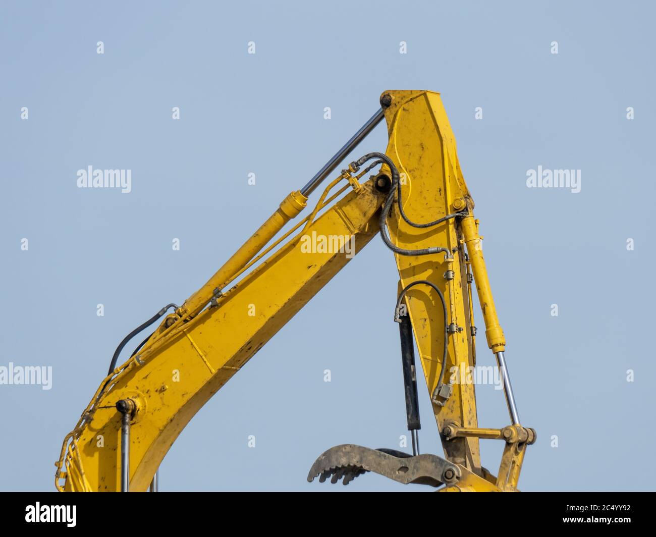 detail of a yellow hydraulic bucket boom arm of a construction digger ...