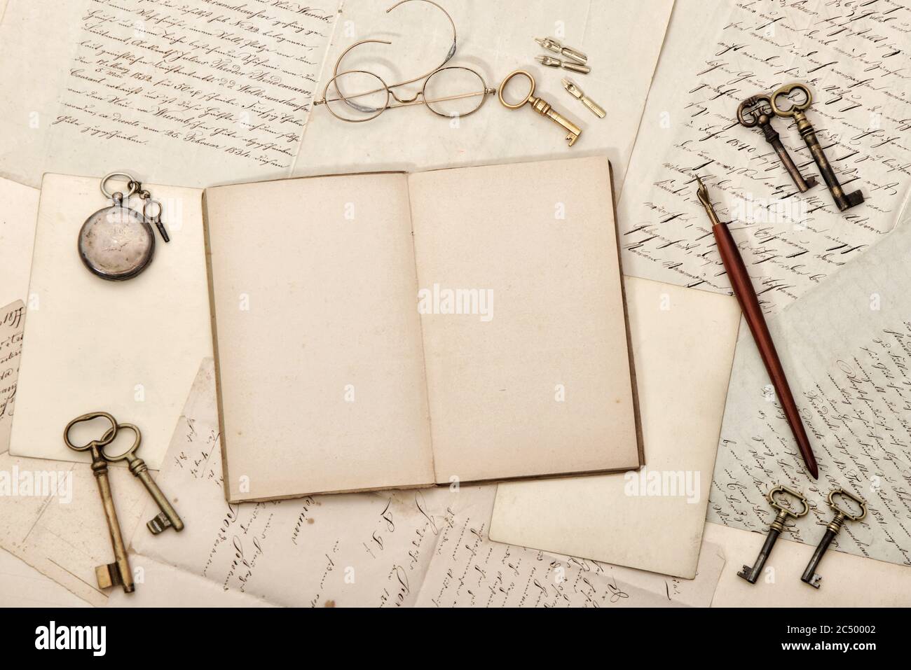Open book, old handwritings, vintage accessories and keys. Nostalgic ...