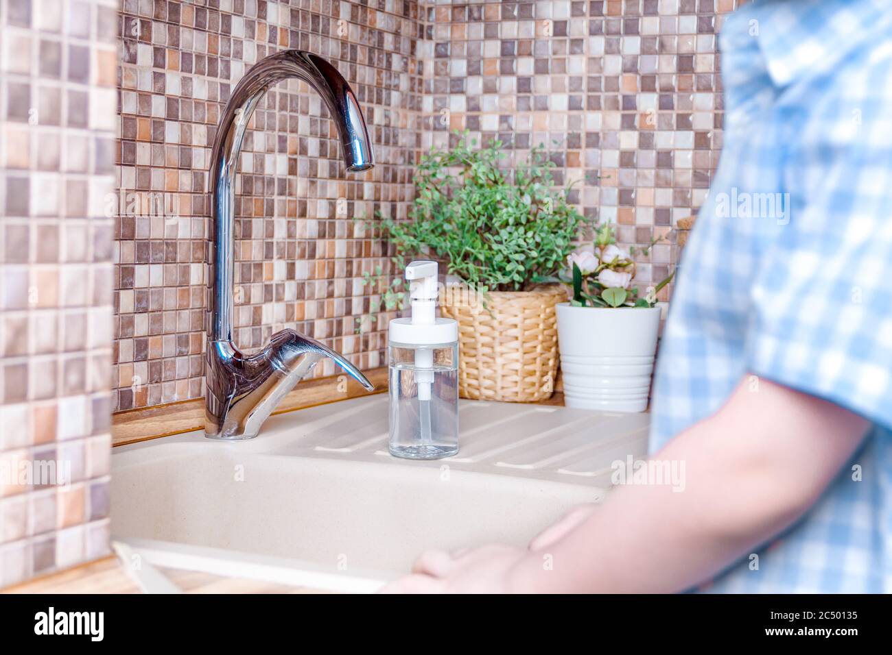 Blur kid hands in brown wooden kitchen sink with plants Stock Photo - Alamy