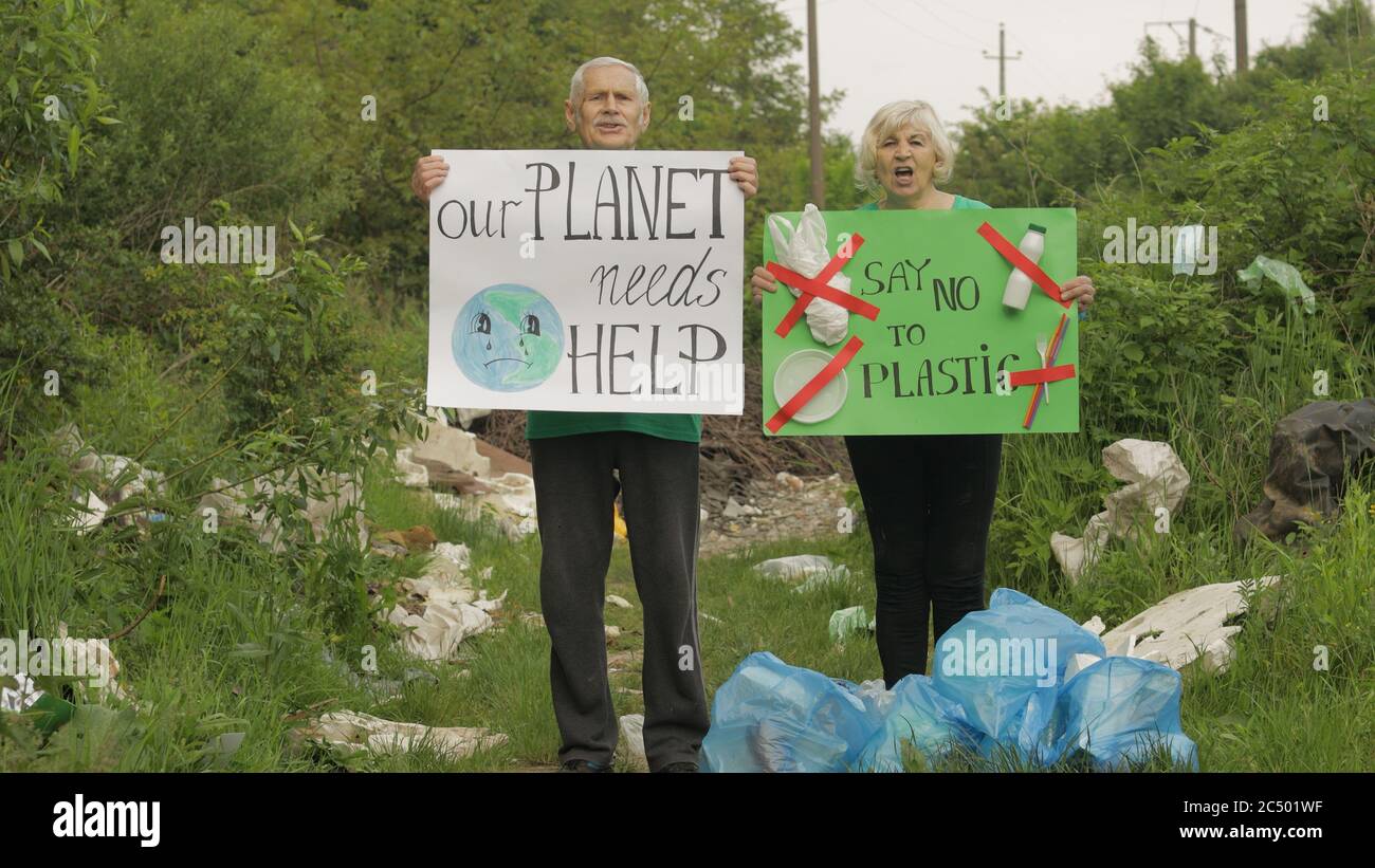 Senior old volunteer activist team holding protesting posters Our ...