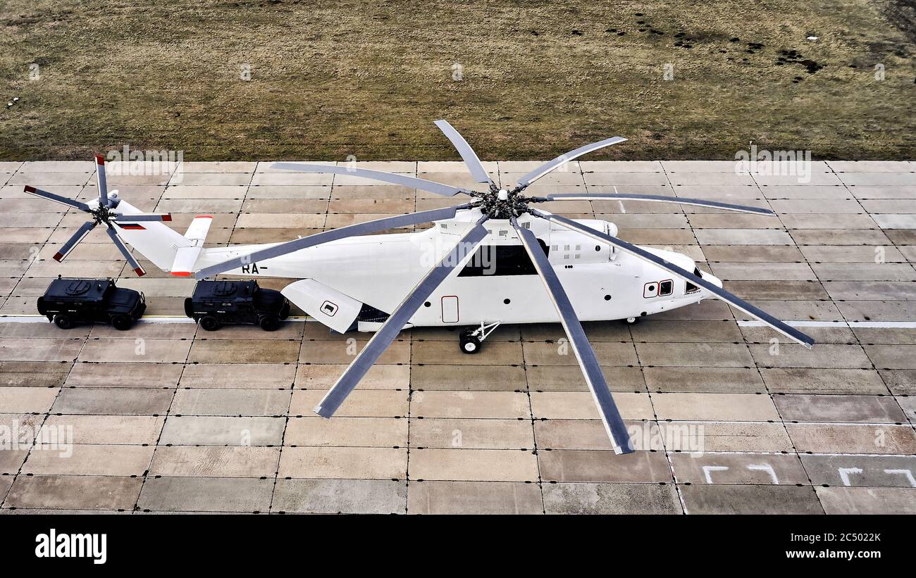 Heavy transport helicopter aerial view. loading equipment on the runway ...