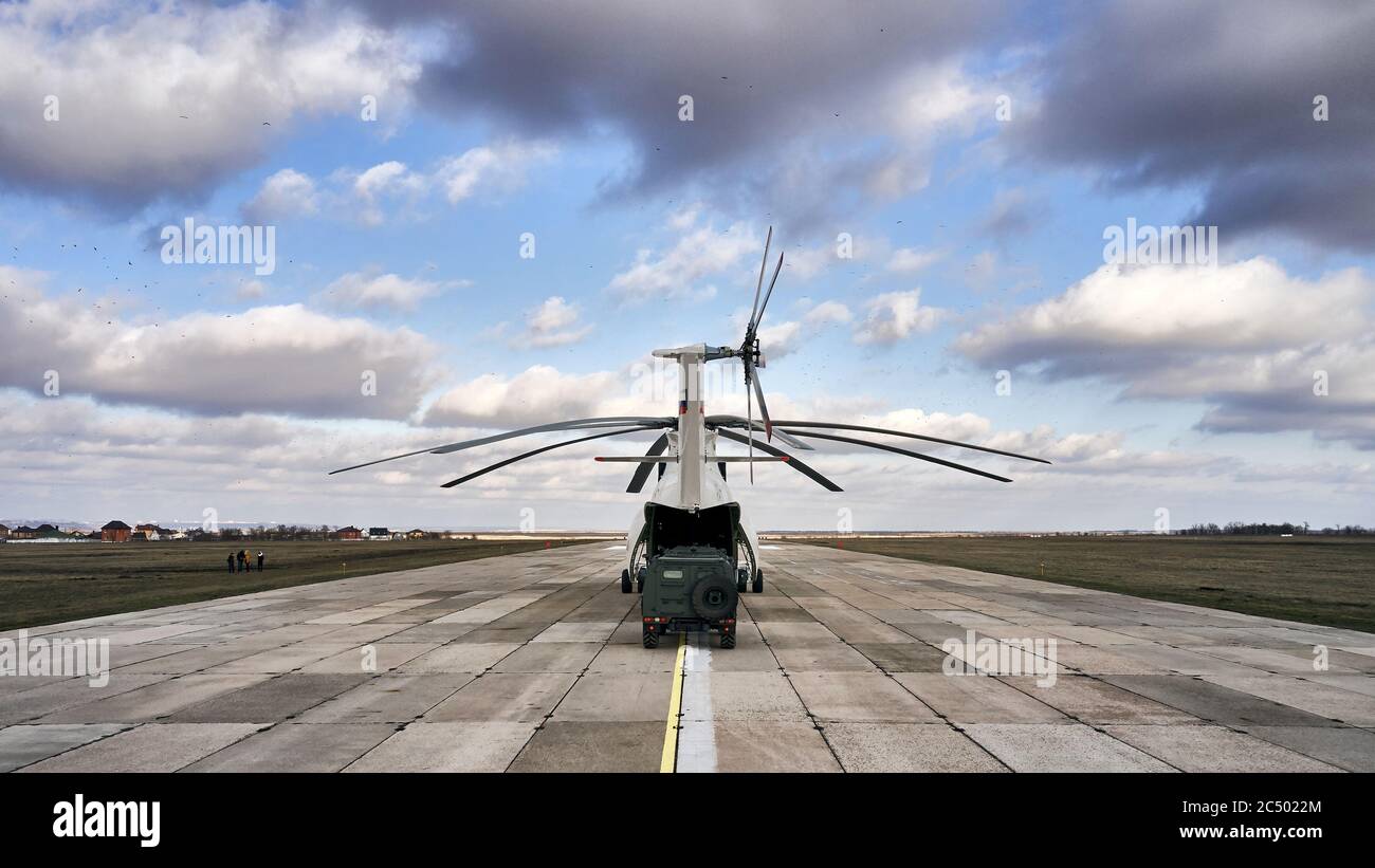 Heavy transport helicopter aerial view. loading equipment on the runway ...