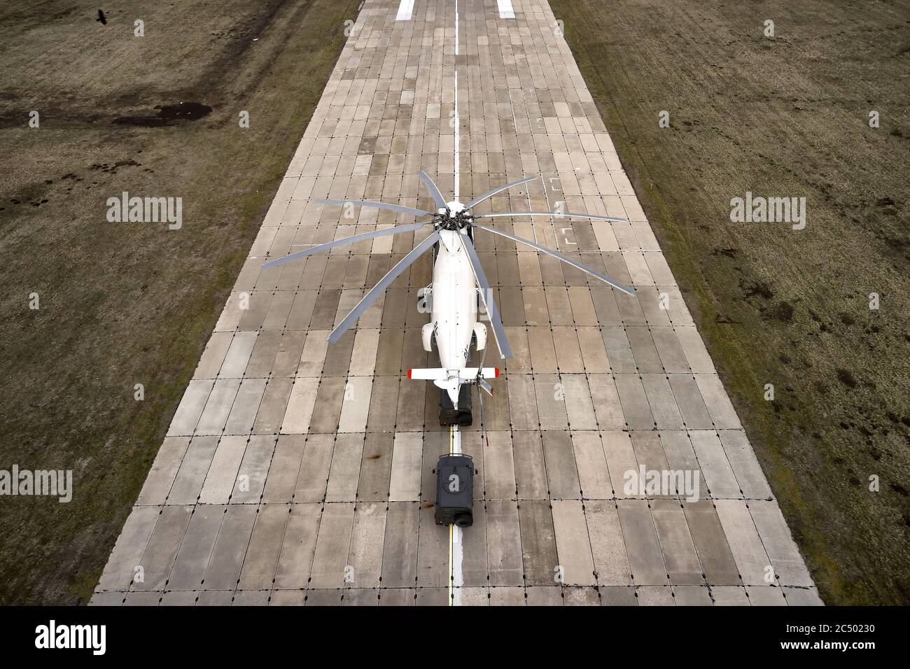 Heavy transport helicopter aerial view. loading equipment on the runway ...