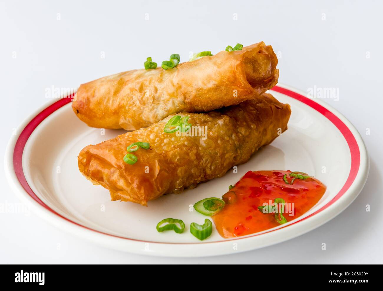 Spring rolls on a plate served with sweet chilli sauce isolated in a ...