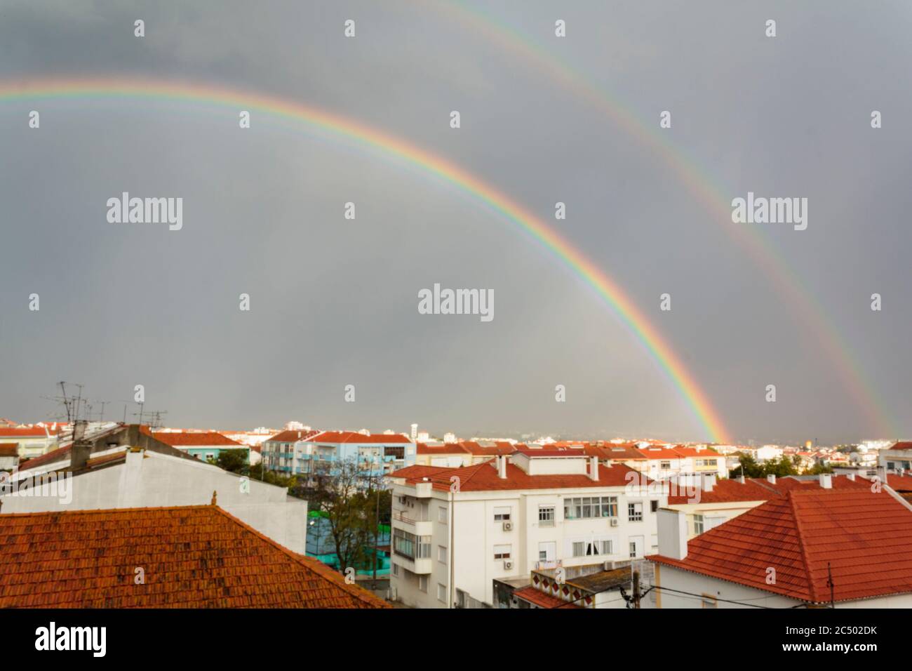 Rainbow over buildings hi-res stock photography and images - Alamy