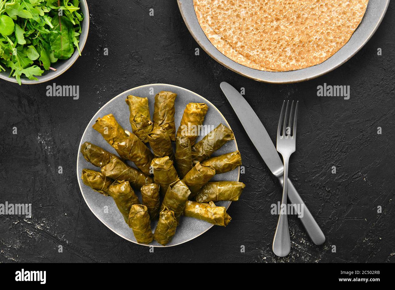 Grape leaves stuffed with meat and rice, traditional dolma on black ...