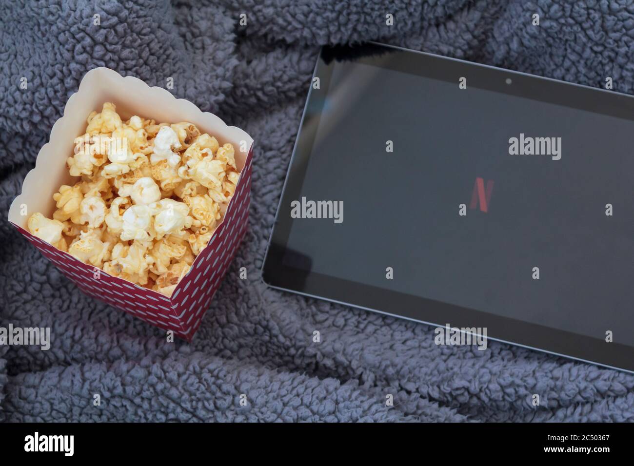 Lisbon, Portugal - CIRCA June 2020: Top view of popcorn box, tablet ...