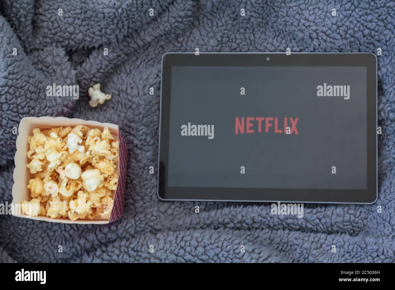 Lisbon, Portugal - CIRCA June 2020: Top view of popcorn box, tablet ...