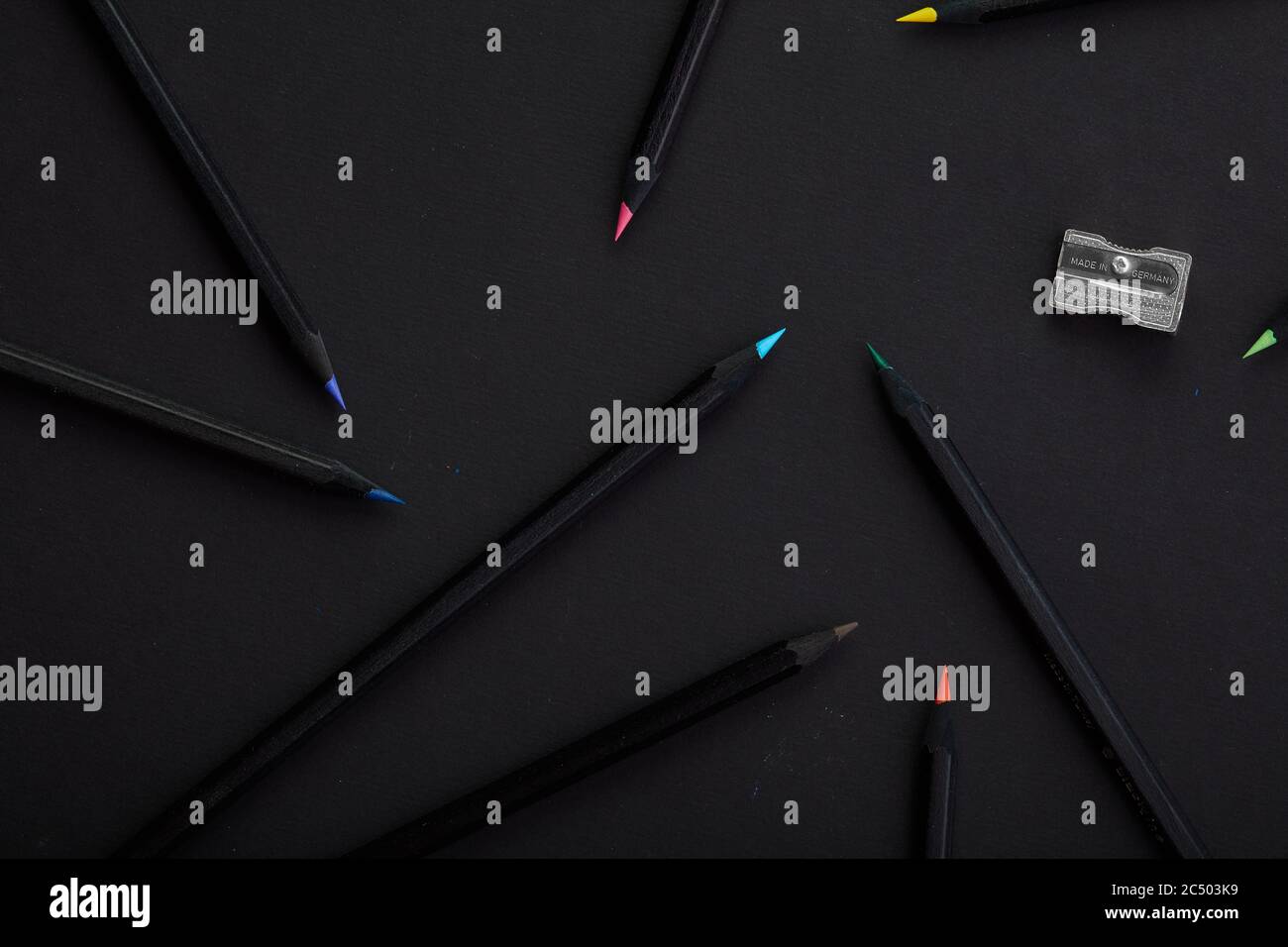 Black colored pencils on black background Stock Photo - Alamy