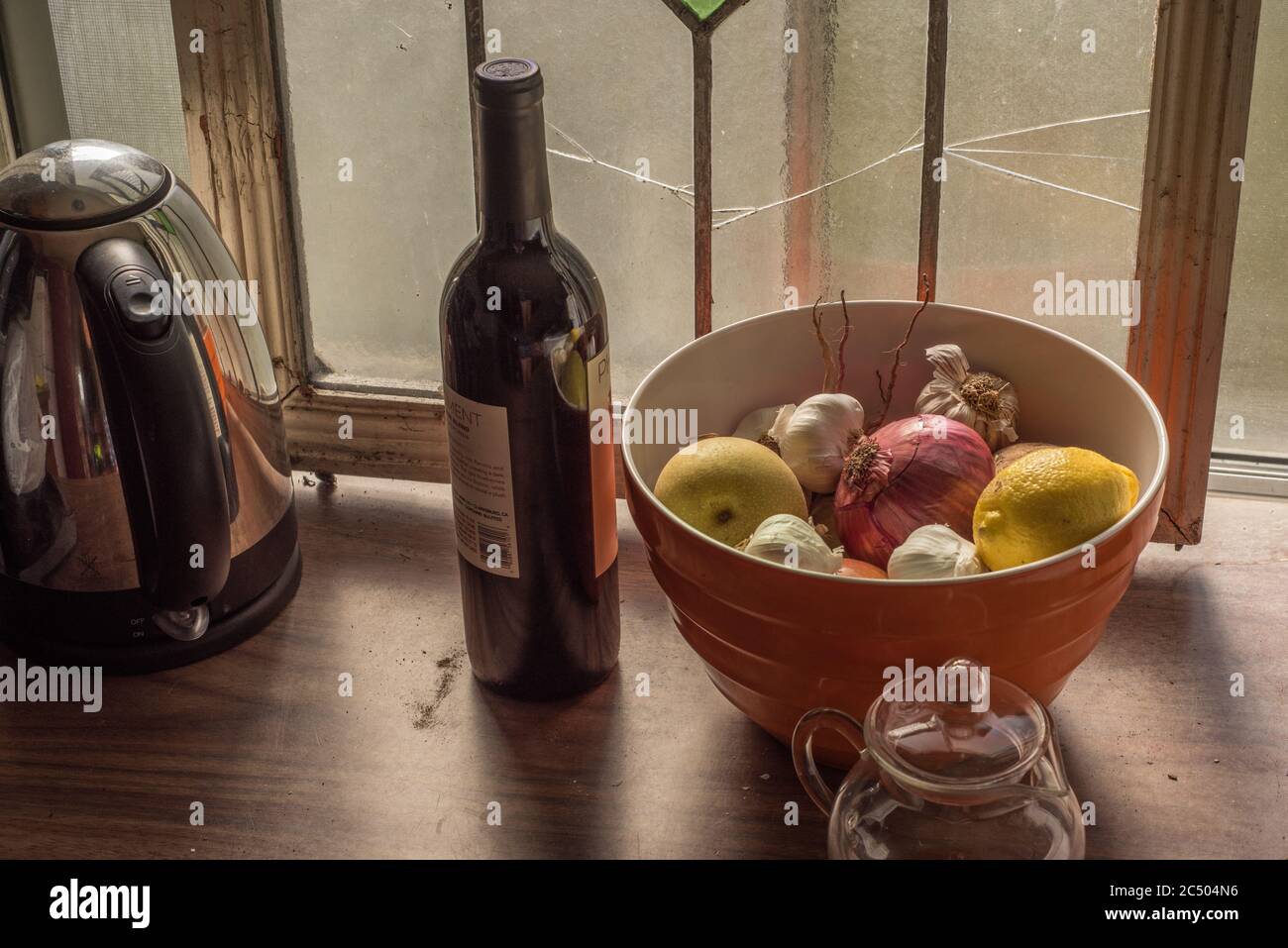 A still life of a bowl of mixed fruit and vegetables sitting on a ...