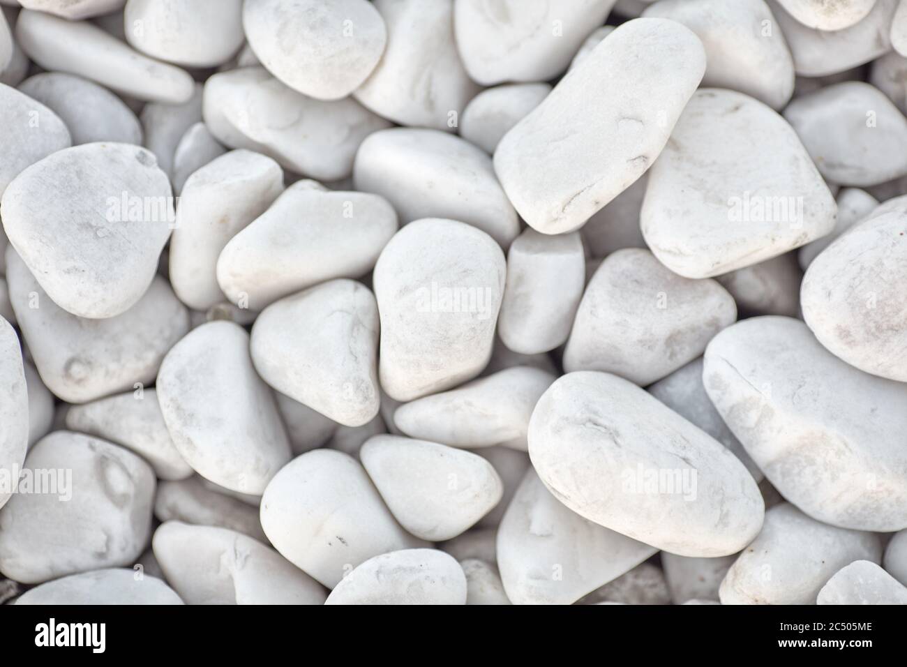 Naturally polished white rock pebbles background. white stones in ...