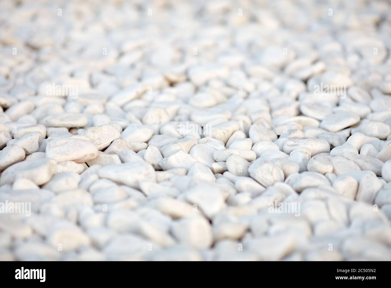 Naturally polished white rock pebbles background. white stones in ...