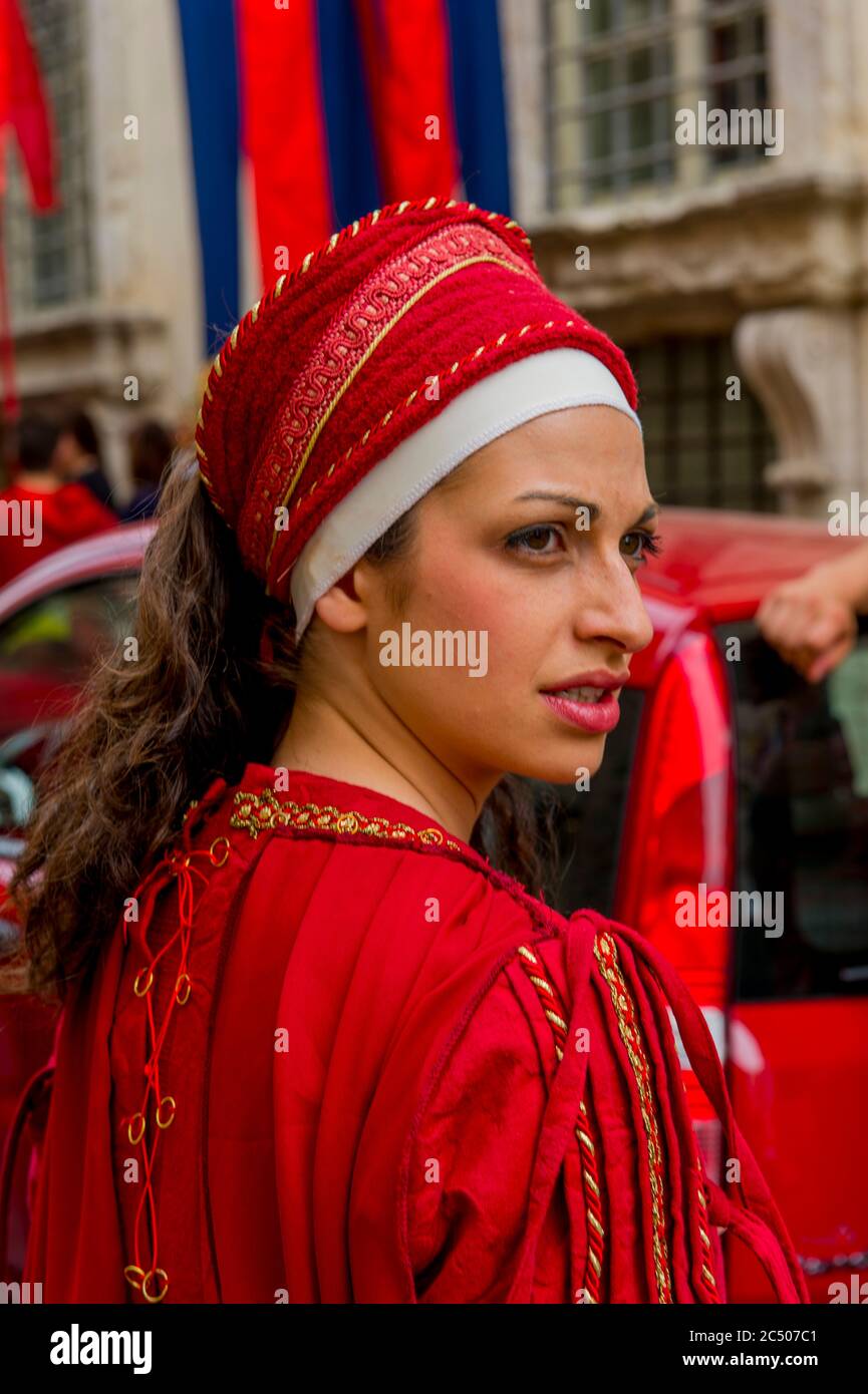 Portrait of a woman in medieval costume in a procession for the Festa ...
